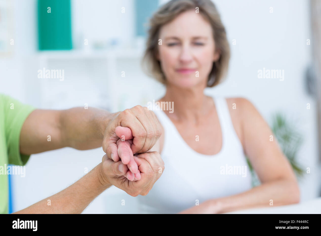 Doctor examining his patients hand Stock Photo - Alamy
