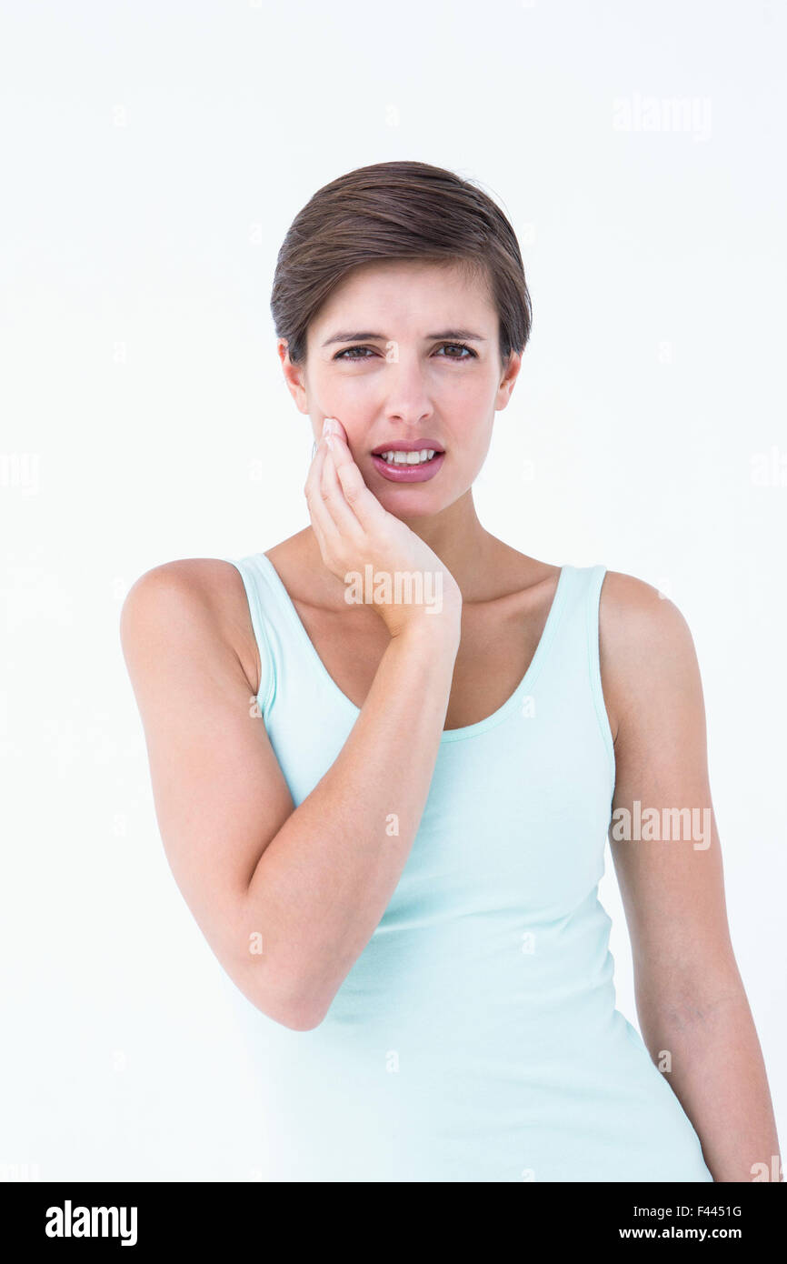 Pretty brunette getting teeth pain Stock Photo - Alamy