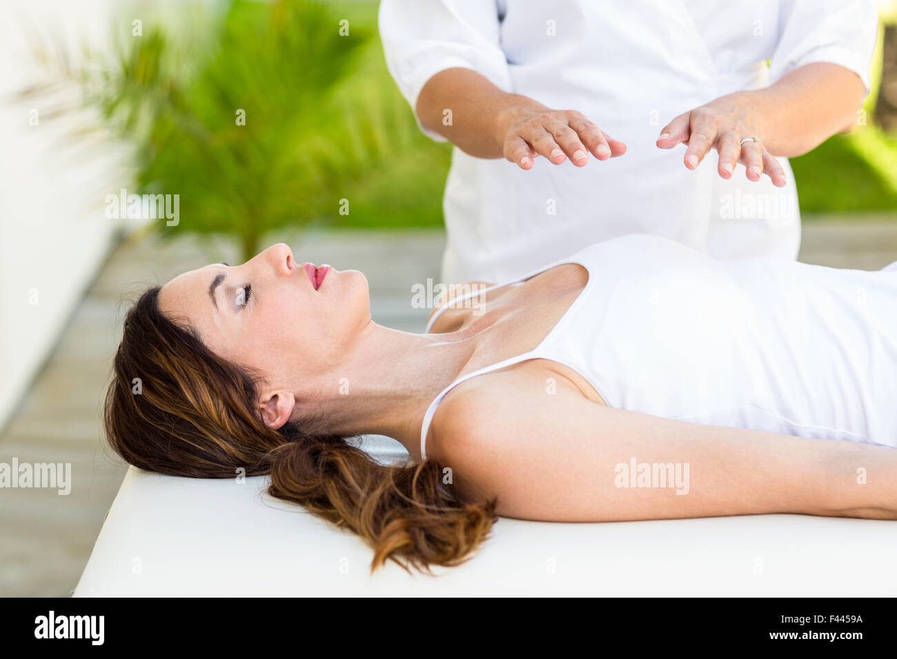 Calm woman receiving reiki treatment Stock Photo - Alamy