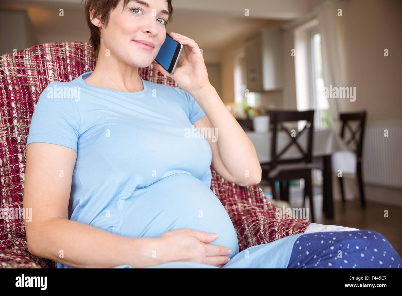 Pregnant woman making a call Stock Photo - Alamy