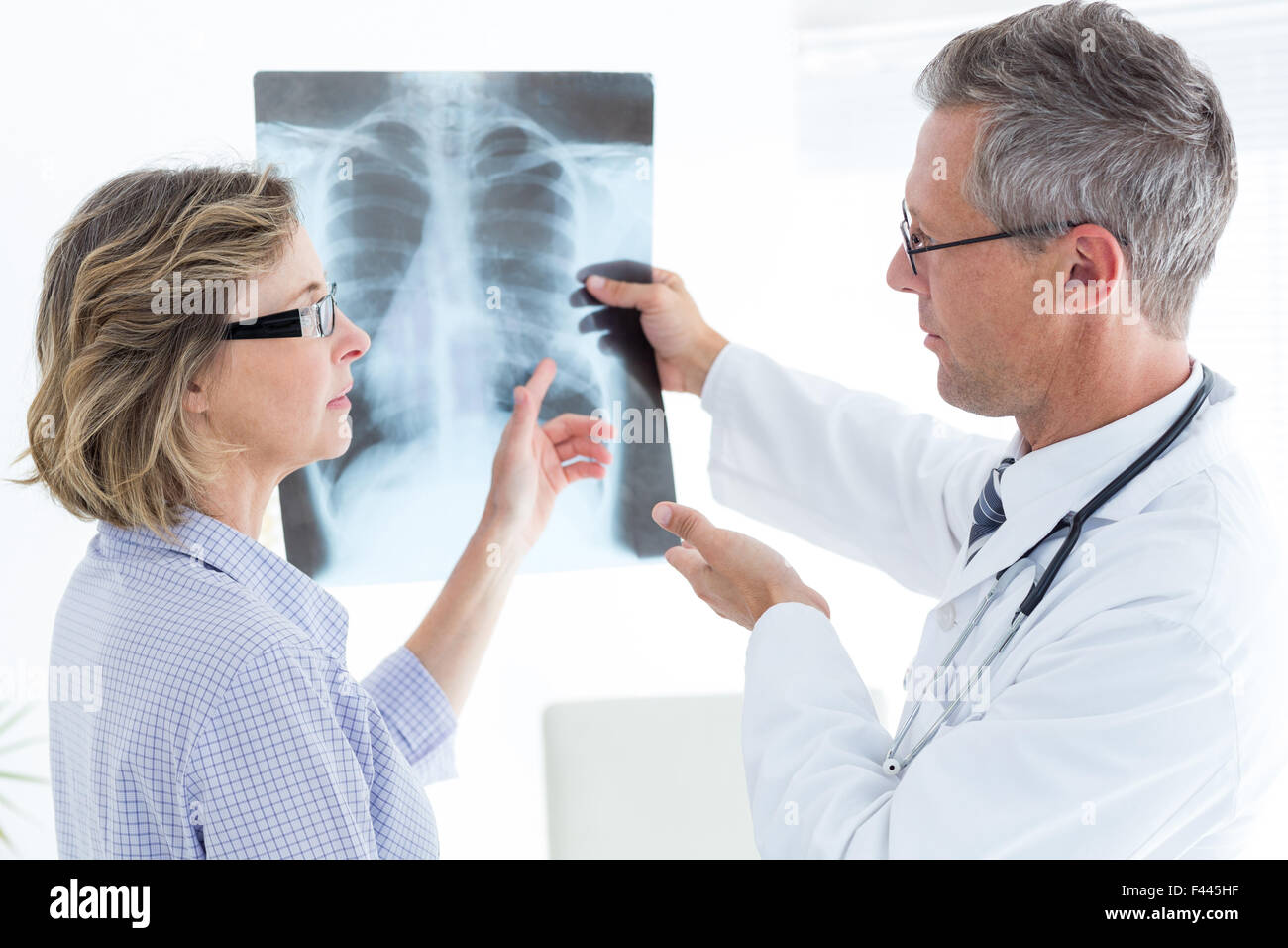 Doctor showing xray to his patient Stock Photo - Alamy