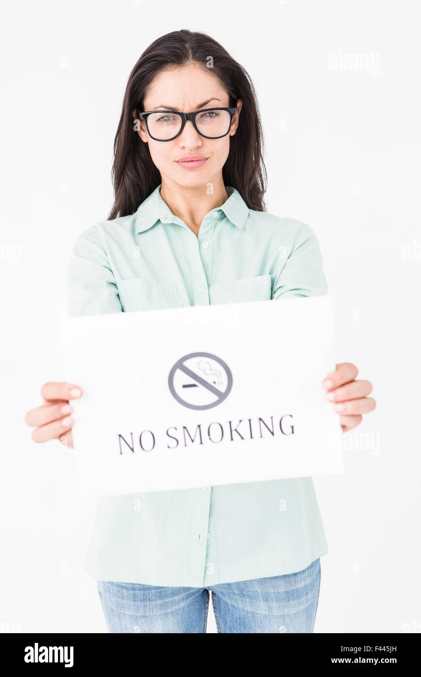 Brunette holding no smoking card Stock Photo - Alamy