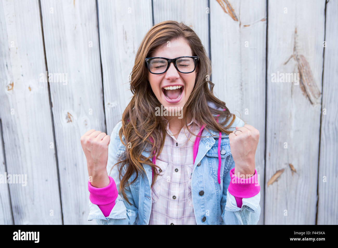 Happy brunette cheering with arms up Stock Photo - Alamy