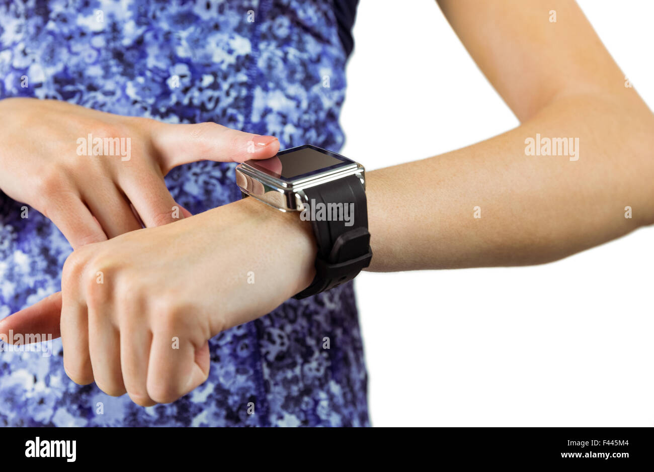 Fit brunette using her smartwatch Stock Photo - Alamy