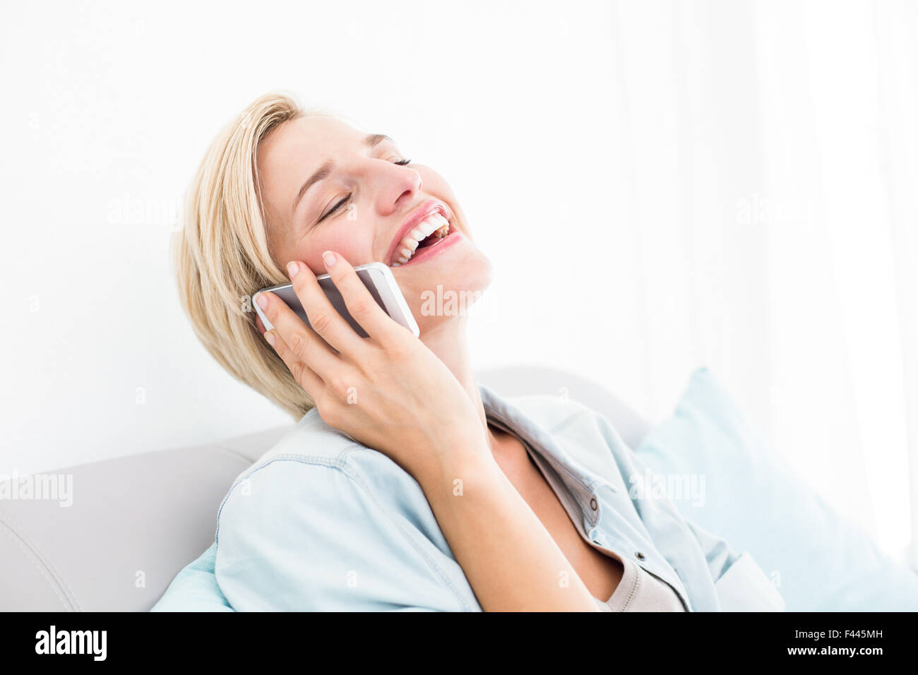 Pretty blonde woman calling on the phone Stock Photo - Alamy