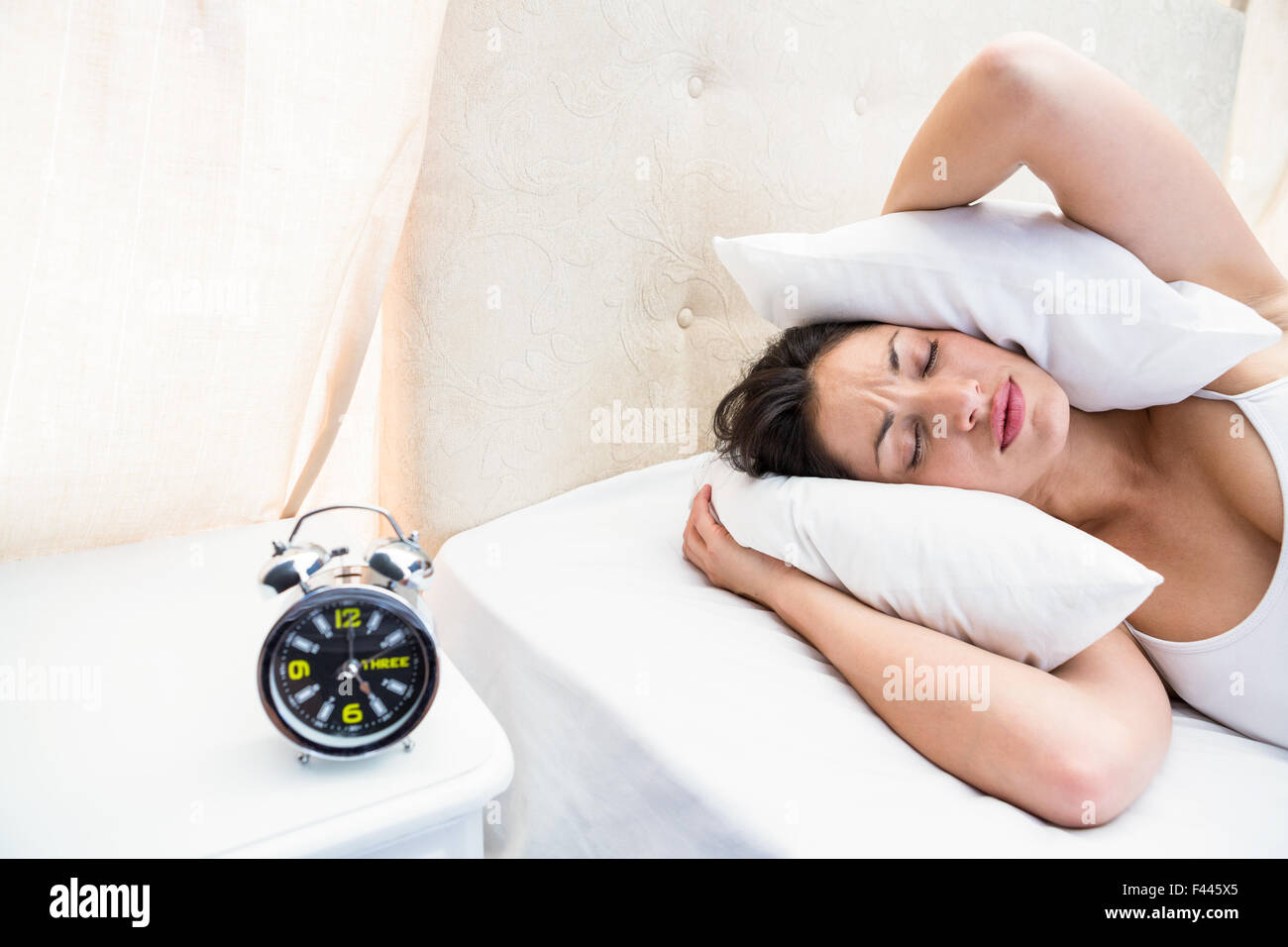 Pretty brunette waking up on bed Stock Photo - Alamy