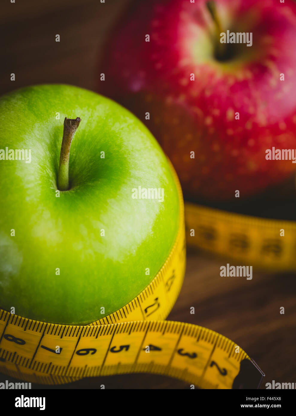 Green and red apples with measuring tape Stock Photo - Alamy
