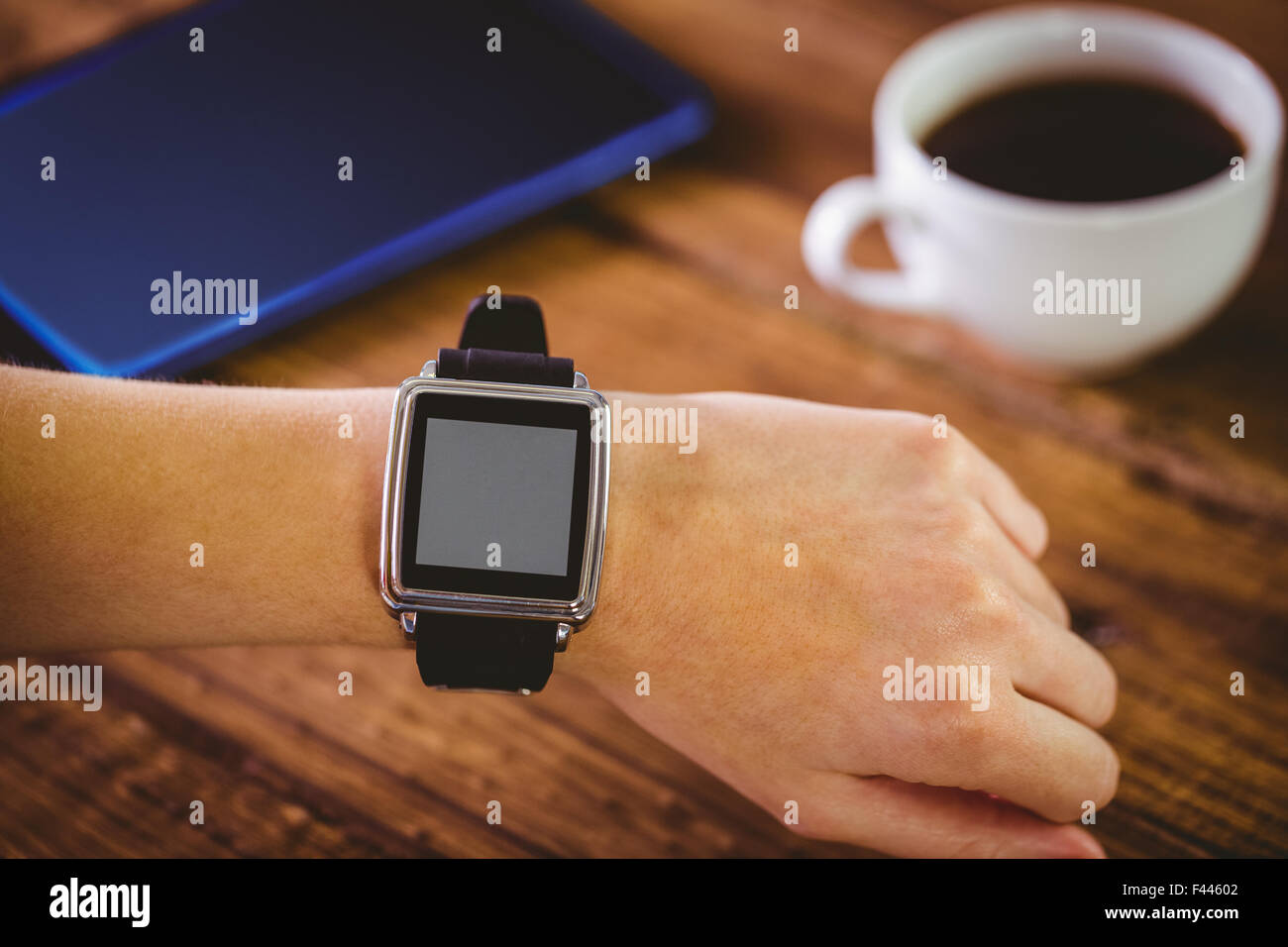 Woman using her smartwatch Stock Photo - Alamy