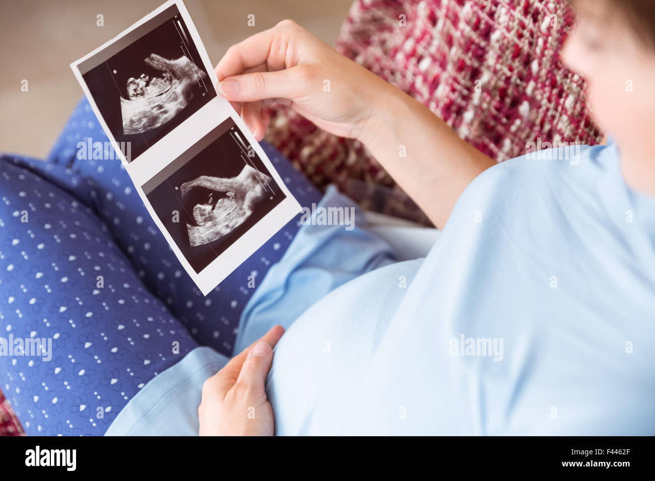 Pregnant woman looking at ultrasound scans Stock Photo - Alamy