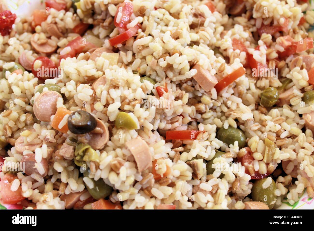 rice salad with olives, capers, sausages and tomatoes Stock Photo - Alamy