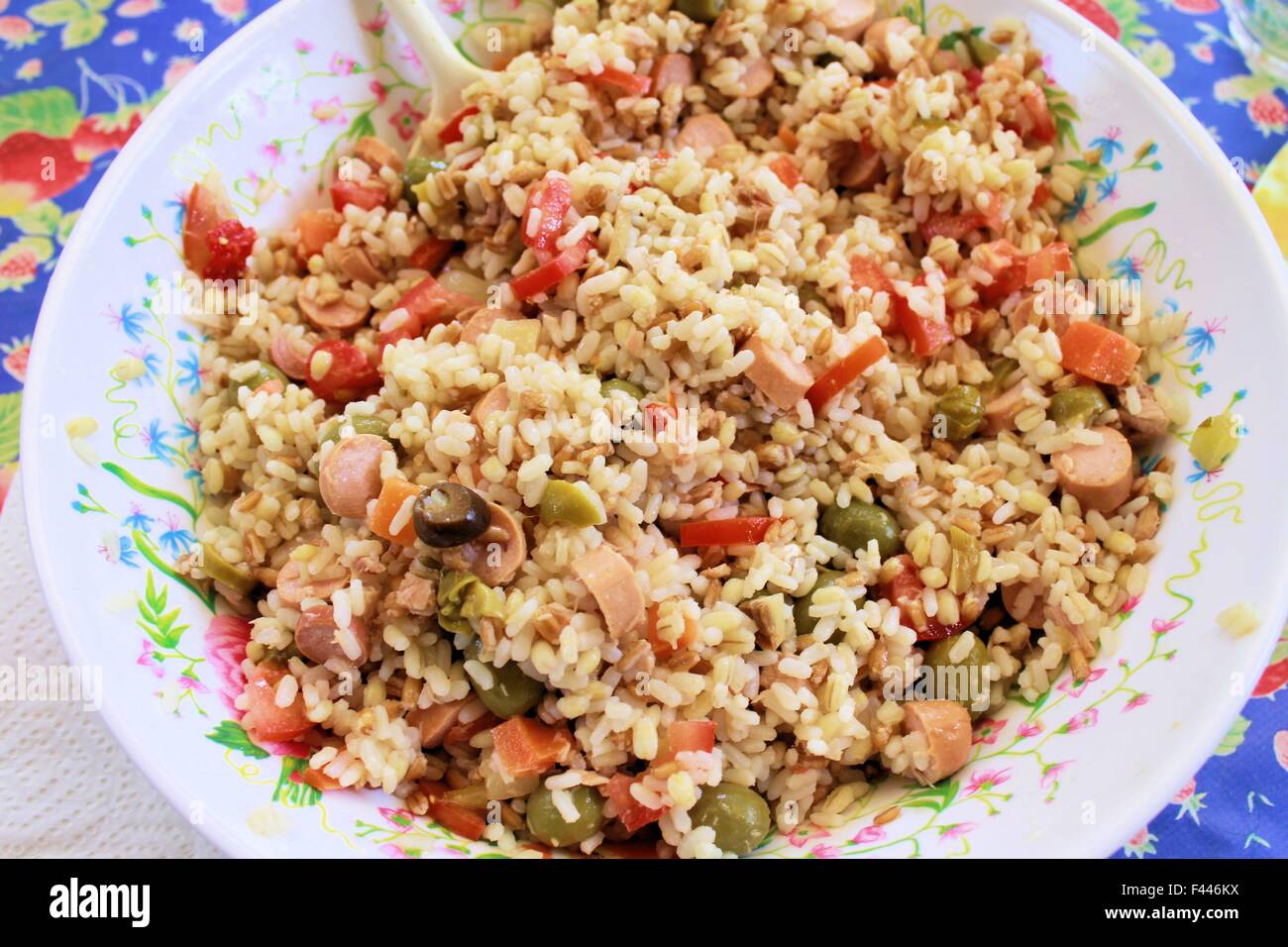 rice salad with olives, capers, sausages and tomatoes Stock Photo - Alamy