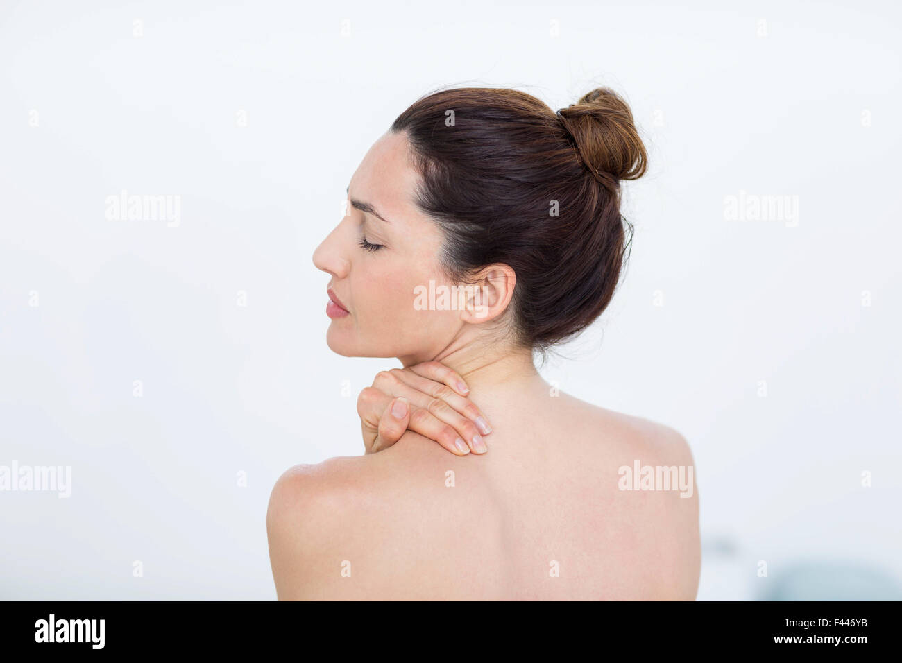 Woman touching her shoulder Stock Photo - Alamy