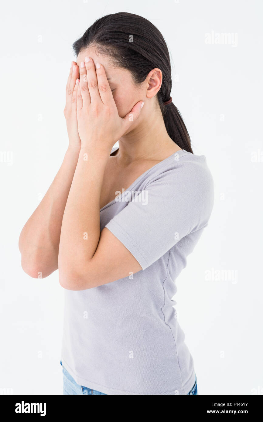 Sad brunette hiding her face Stock Photo - Alamy