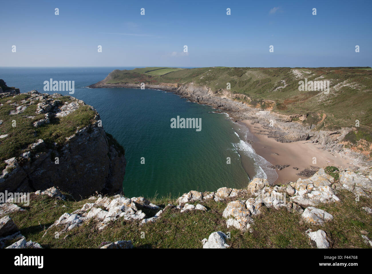 Steep cliffs and crystal clear water at Fall Bay, near Rhossili on the ...