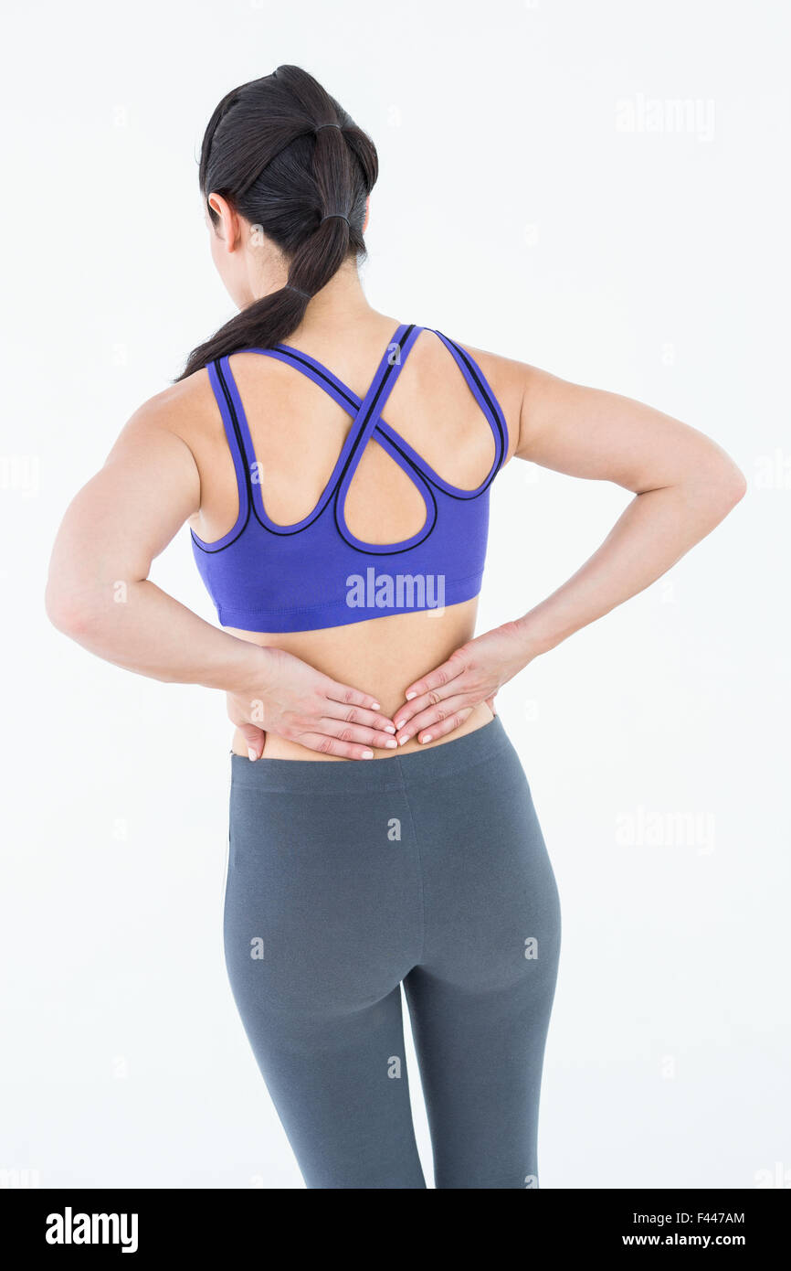Fit woman suffering from back pain Stock Photo - Alamy