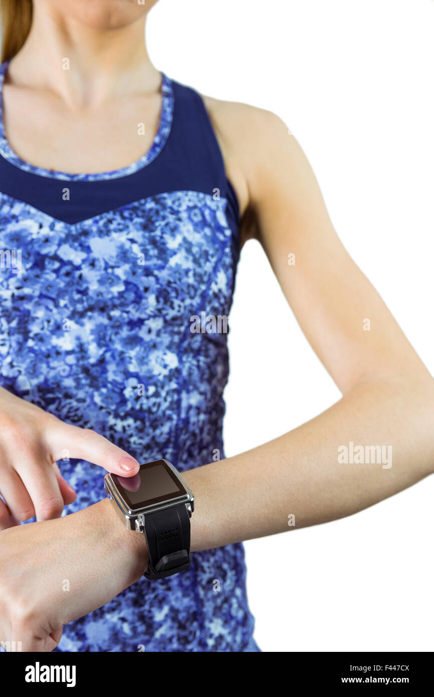 Fit brunette using her smartwatch Stock Photo - Alamy