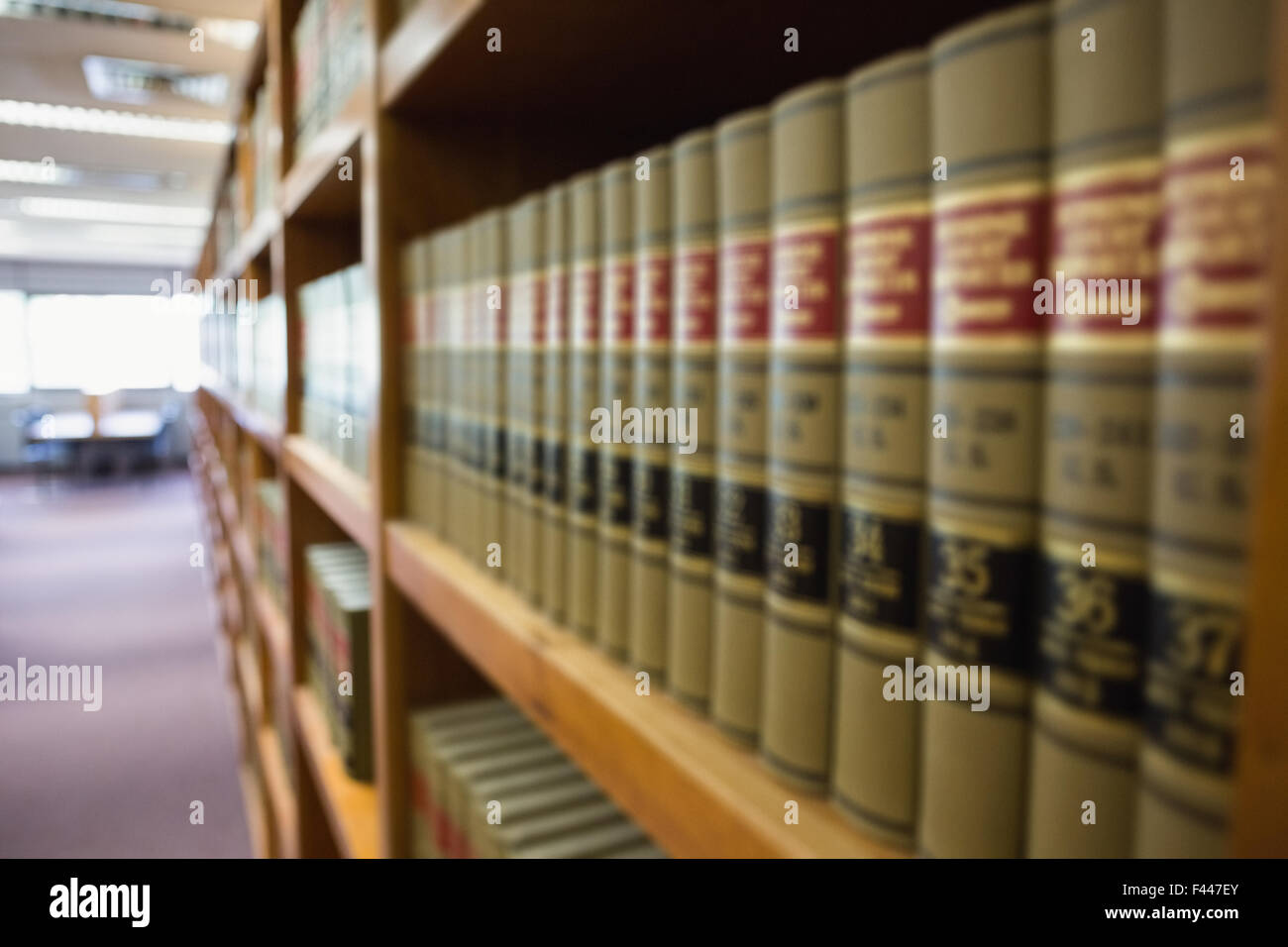 Volumes of books on bookshelf in library Stock Photo - Alamy