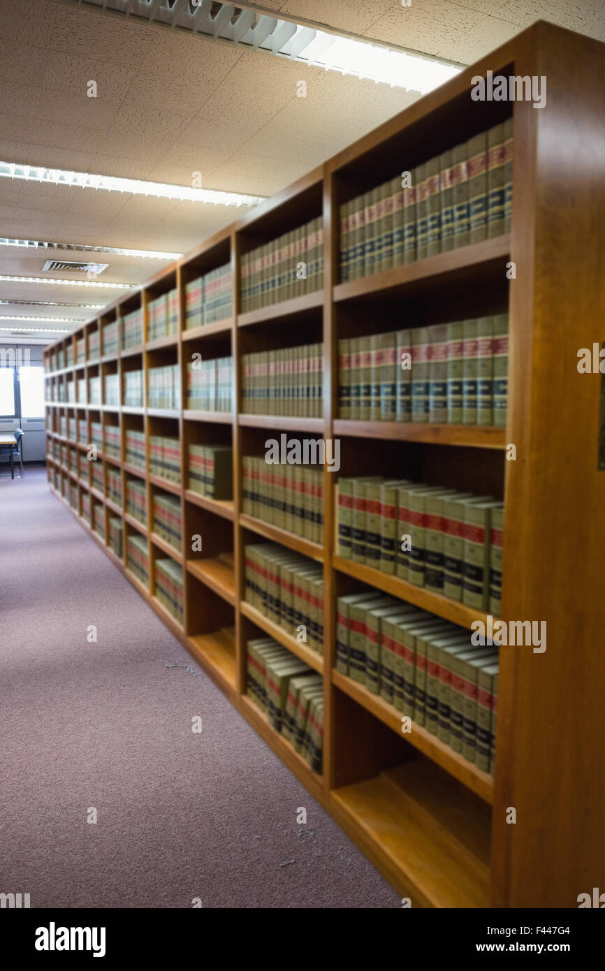 Volumes of books on bookshelf in library Stock Photo - Alamy