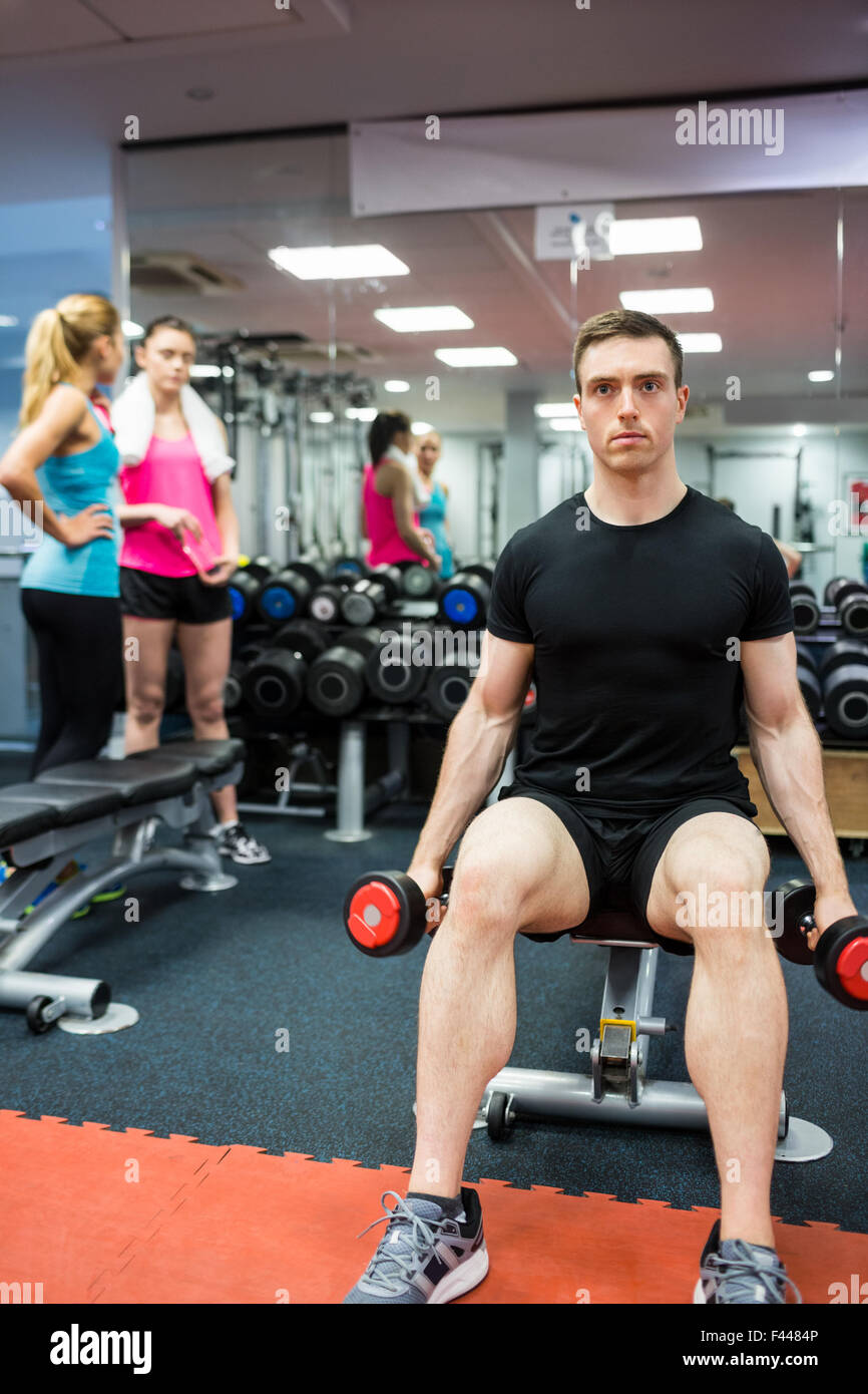Fit man lifting heavy black dumbbells Stock Photo - Alamy