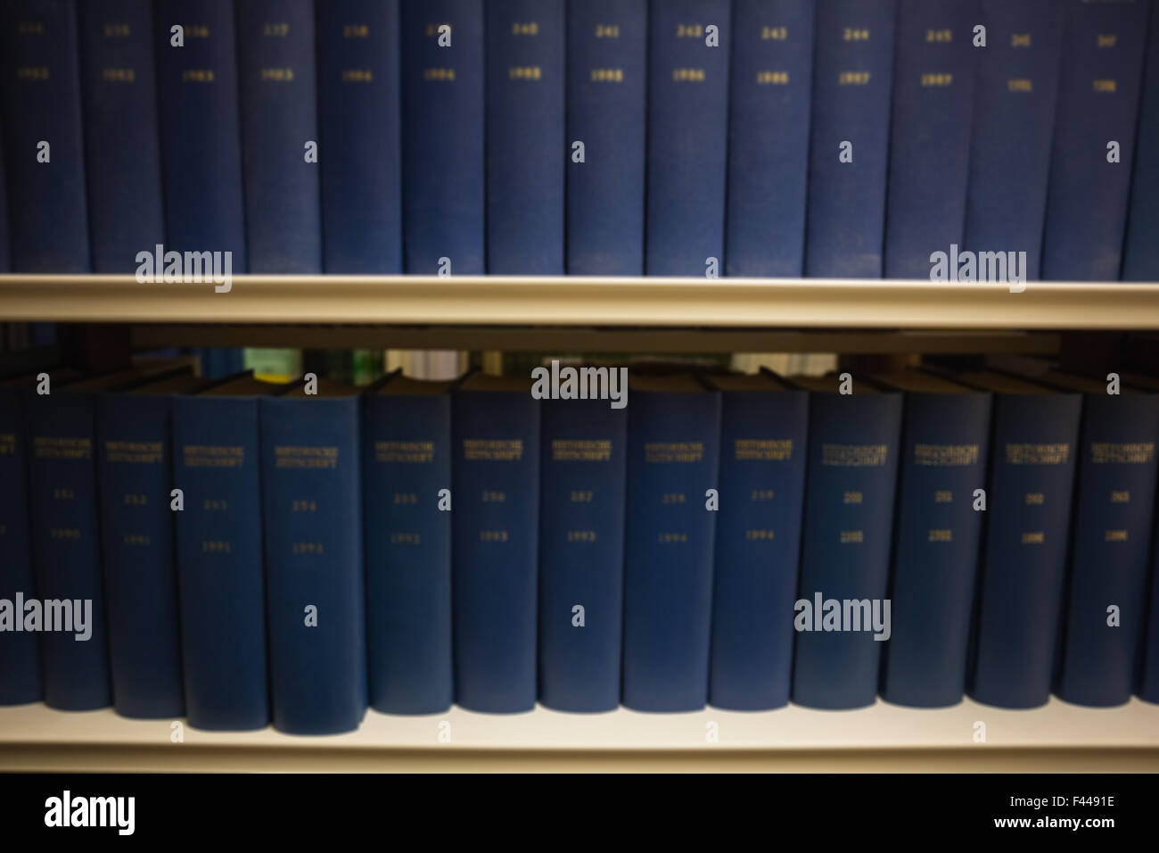 Volumes of books on bookshelf in library Stock Photo - Alamy
