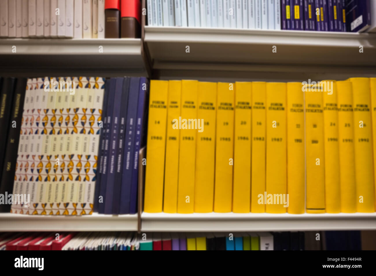 Volumes of books on bookshelf in library Stock Photo - Alamy