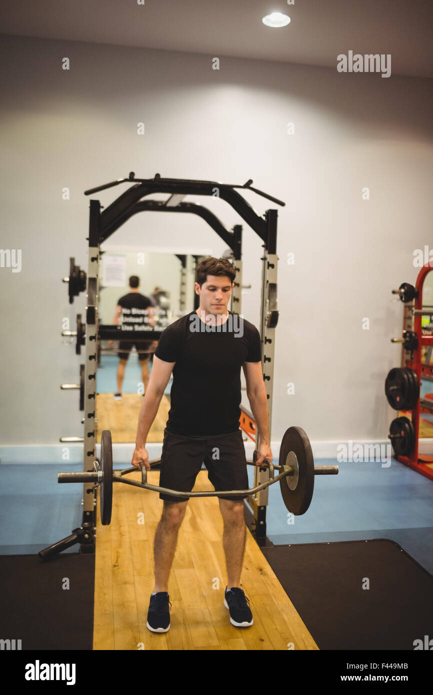 Fit man lifting heavy barbell Stock Photo - Alamy