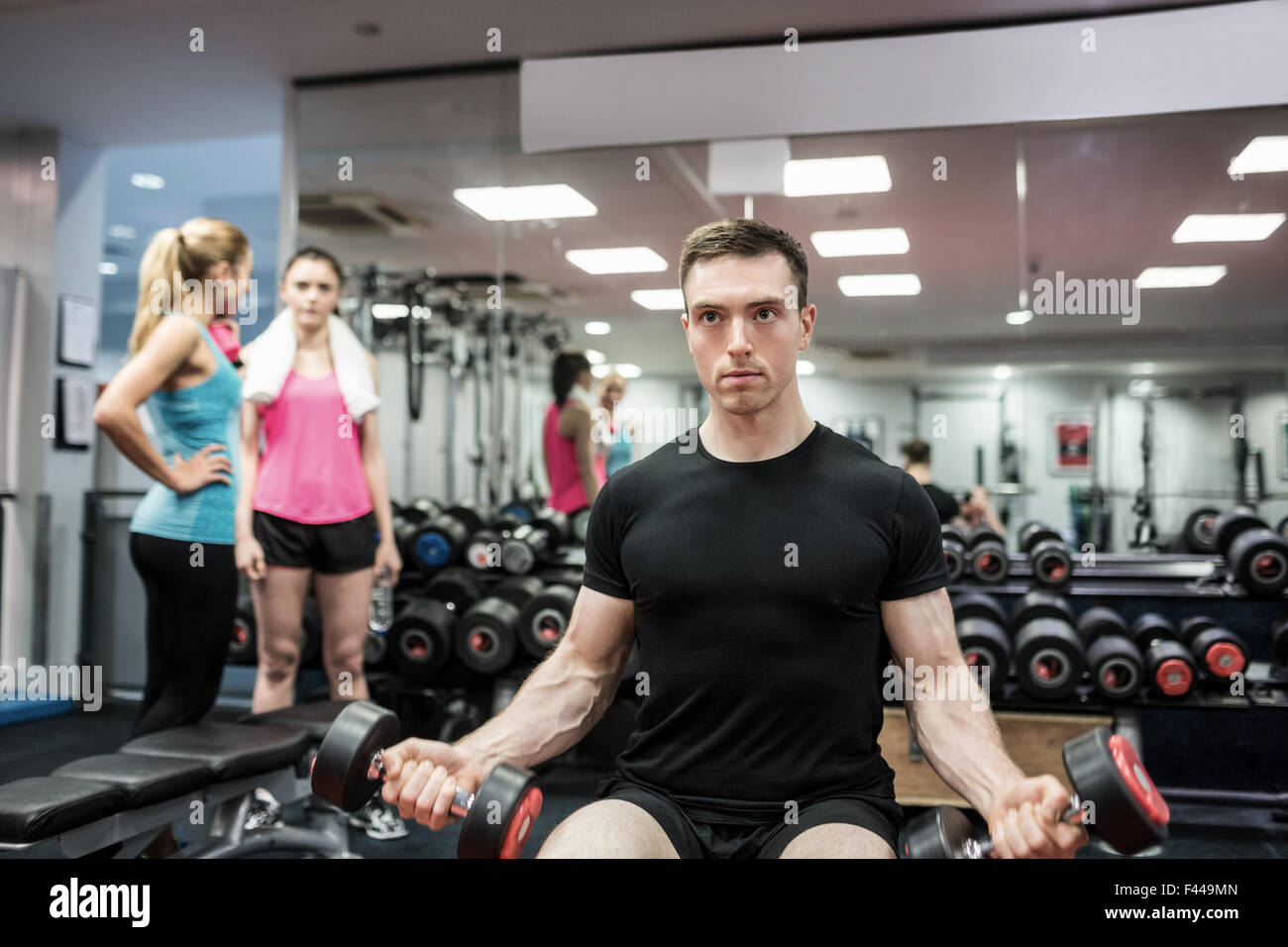 Fit man lifting heavy black dumbbells Stock Photo - Alamy