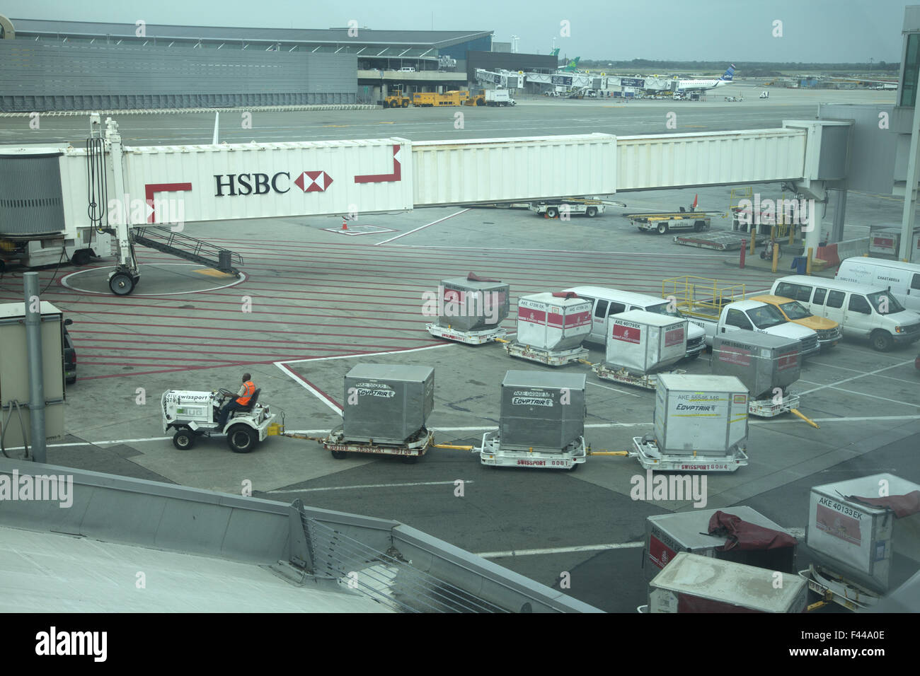 Worker pulls cargo containers to and from airplanes at JFK ...