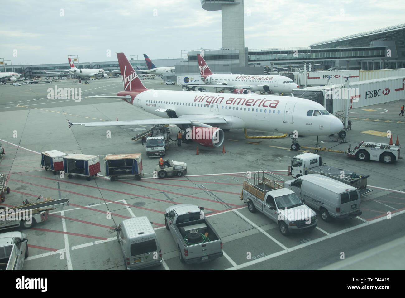 Worker pulls cargo containers to and from airplanes at JFK ...