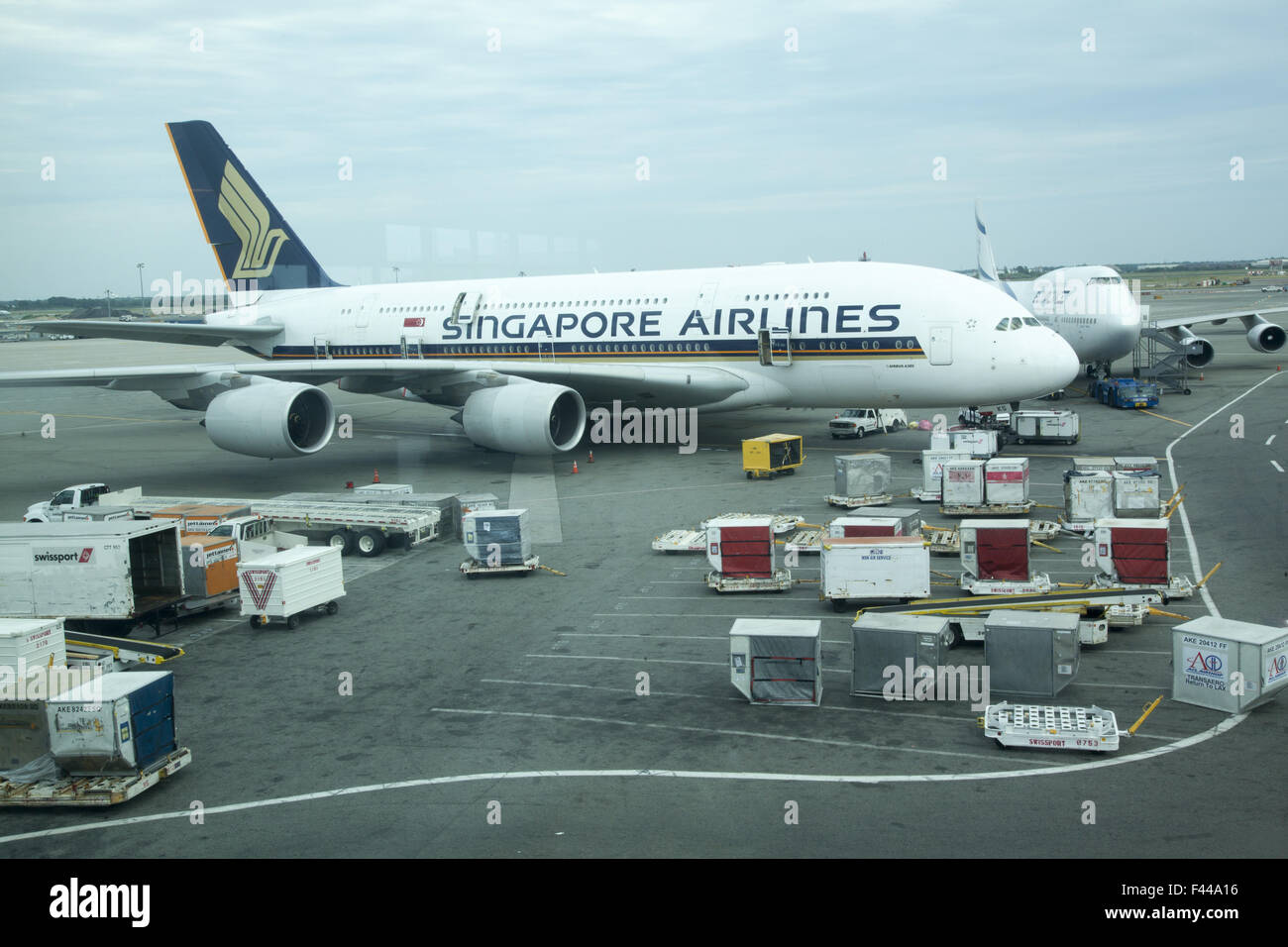 Workers load & unload cargo containers on and off airplanes at JFK ...
