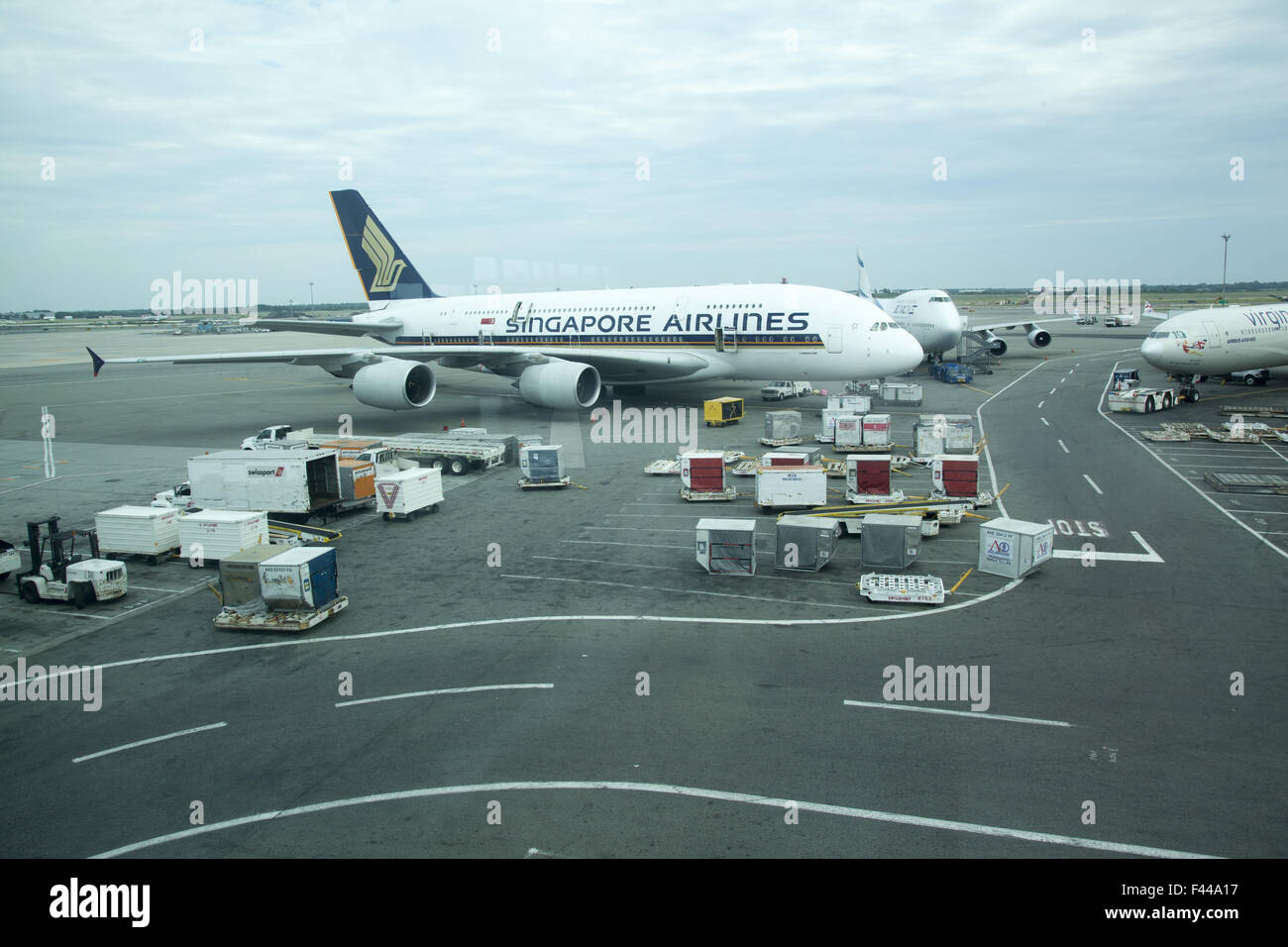 Workers load & unload cargo containers on and off airplanes at JFK ...