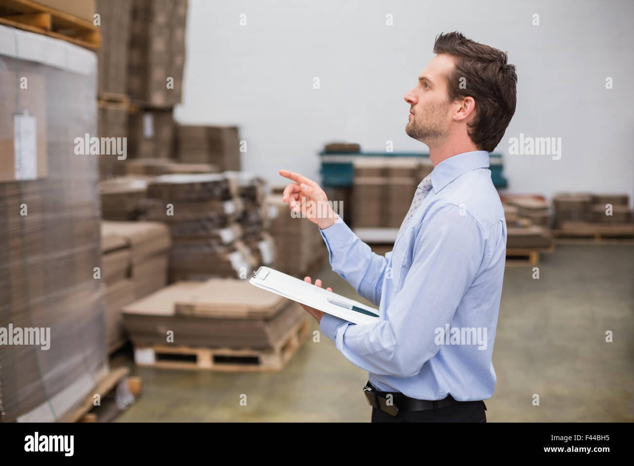 Warehouse manager checking his inventory Stock Photo - Alamy