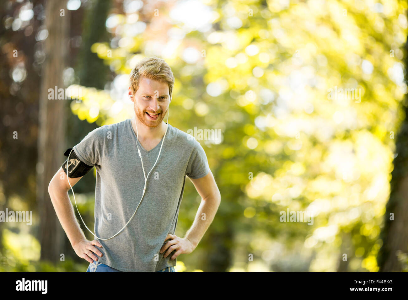 Young man running in the autumn park Stock Photo - Alamy