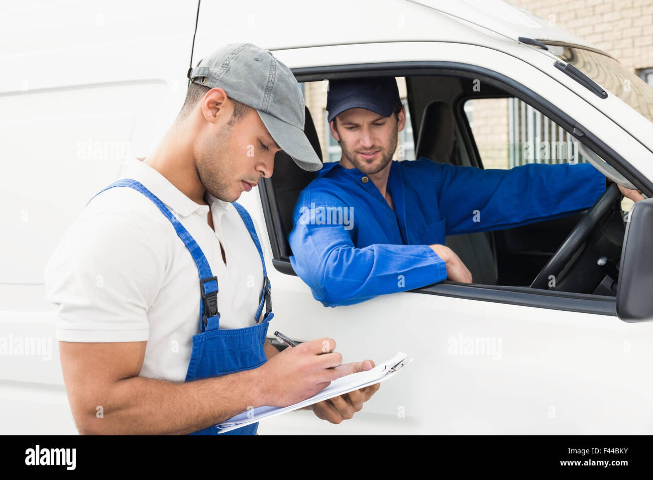Customer signing delivery from courier hi-res stock photography and ...
