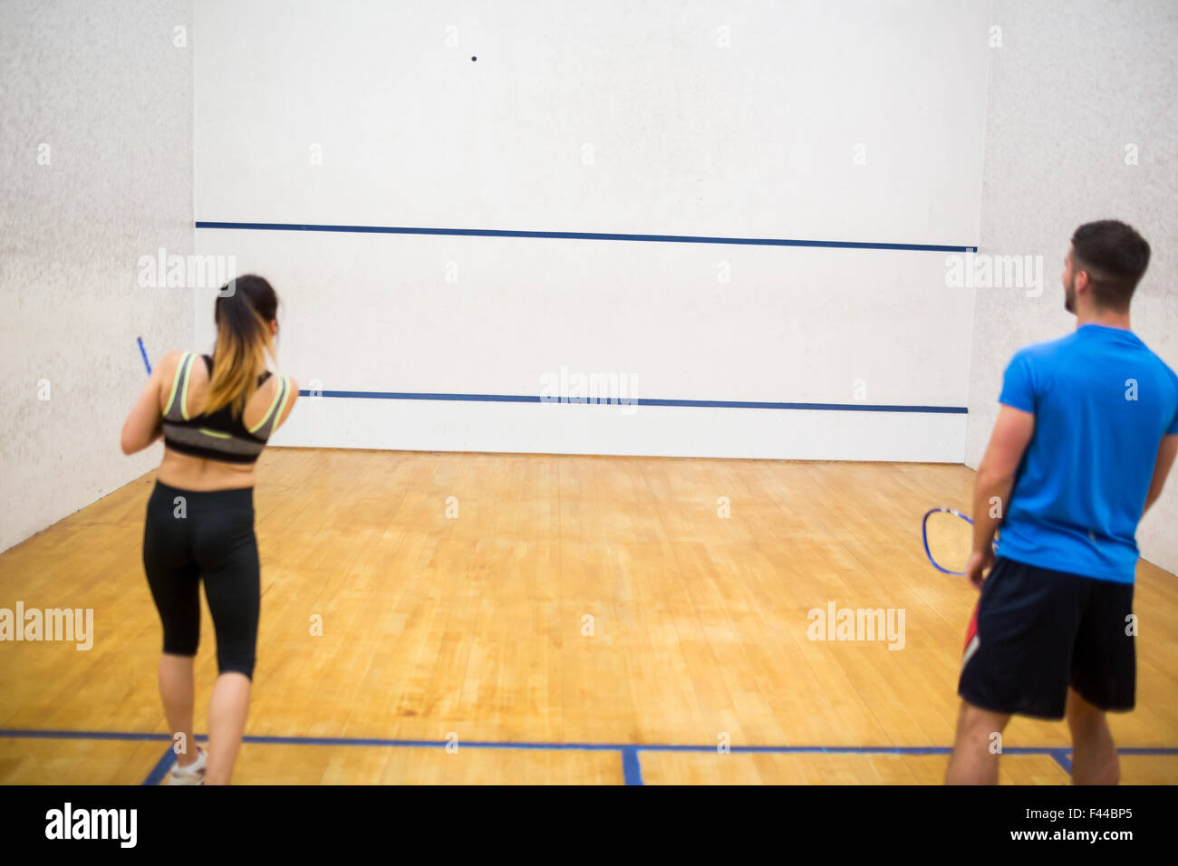 Couple play some squash together Stock Photo - Alamy