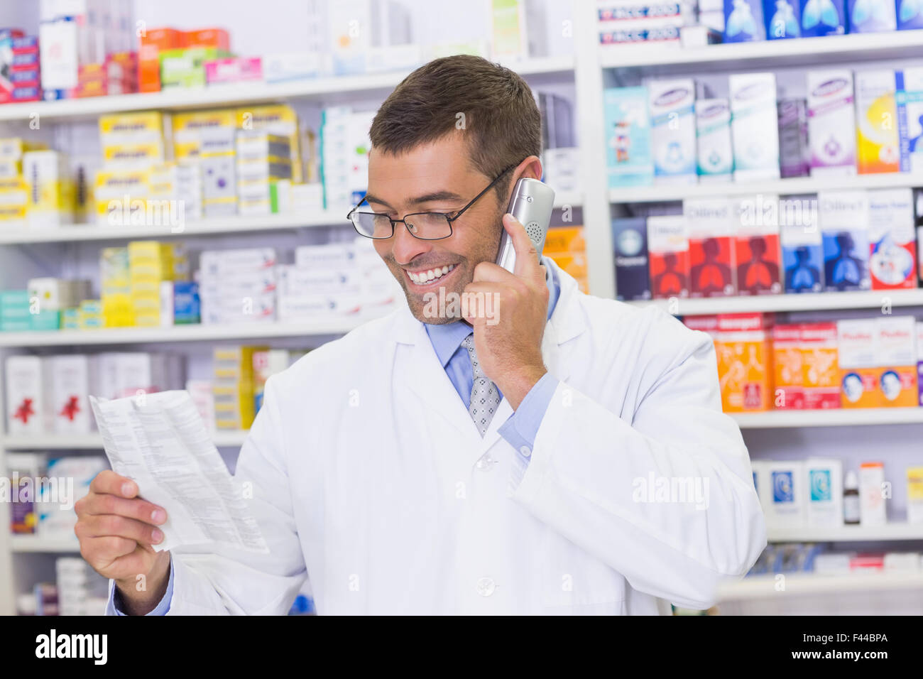 Happy pharmacist on the phone Stock Photo - Alamy