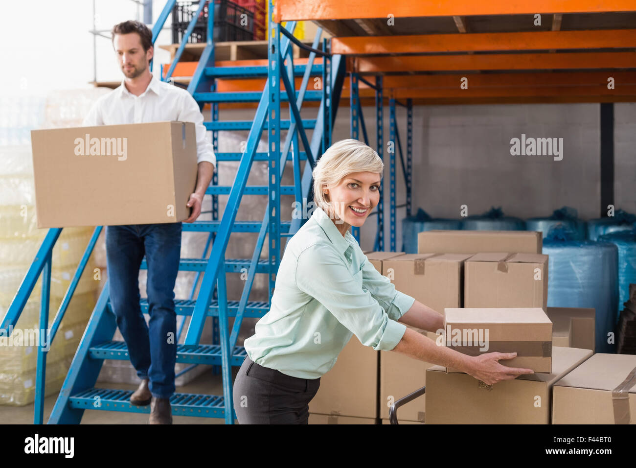 Woman delivery cardboard boxes trolley hi-res stock photography and ...