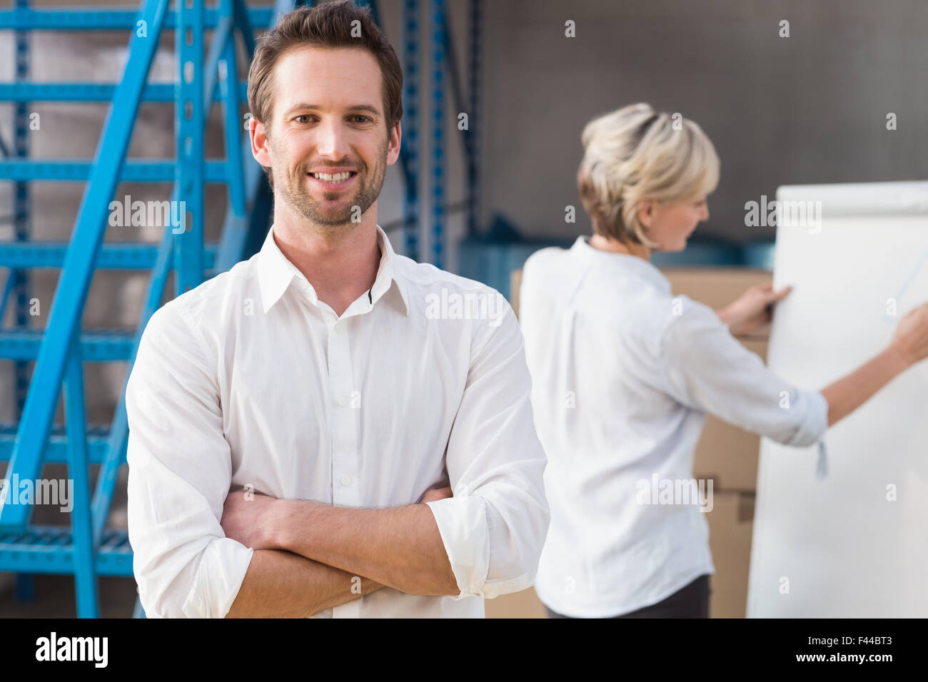 Warehouse manager smiling at camera Stock Photo - Alamy