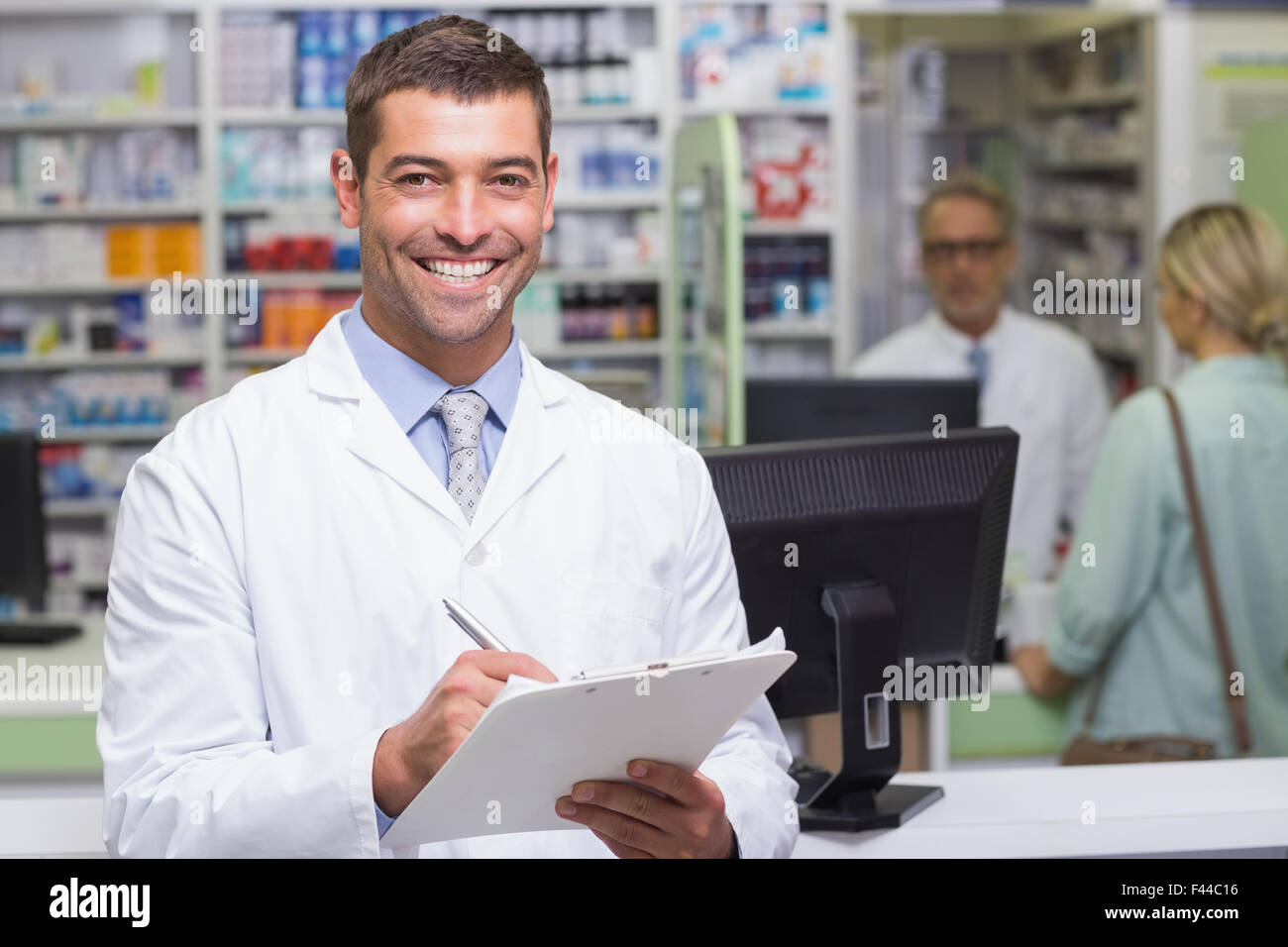 Happy pharmacist looking at camera Stock Photo - Alamy