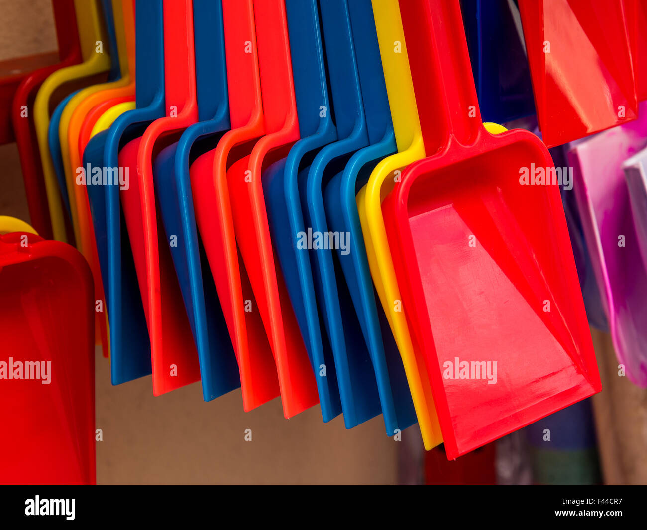 Multicoloured children's spades outside a seaside shop Stock Photo - Alamy