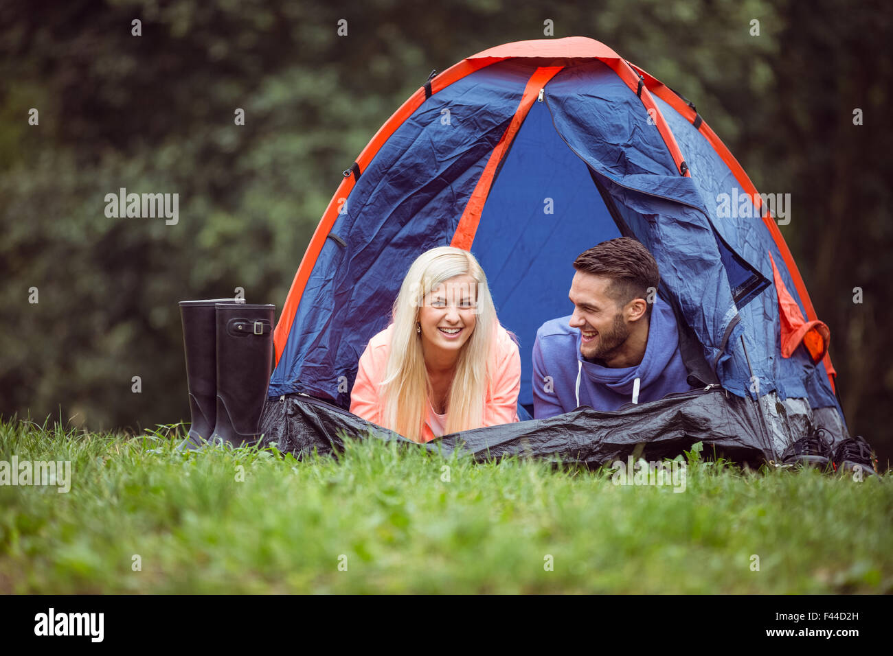 Happy couple lying in their tent Stock Photo - Alamy