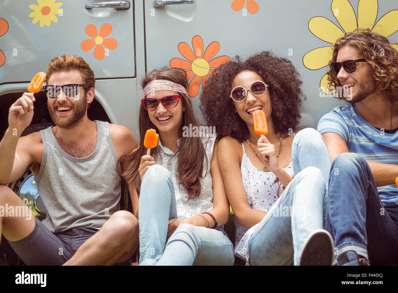 Hipster friends enjoying ice lollies Stock Photo - Alamy