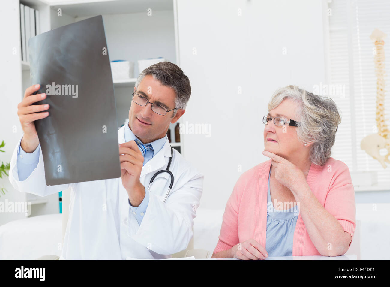Doctor explaining x-ray to female patient Stock Photo - Alamy