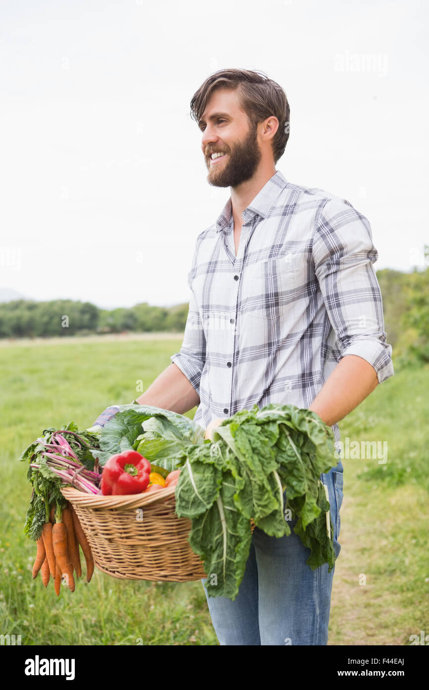 Handsome farmer with basket of veg Stock Photo - Alamy