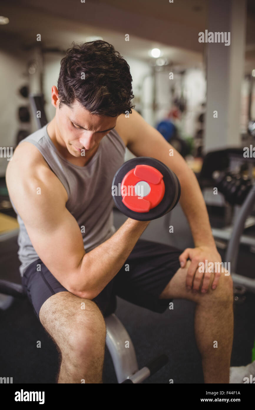 Fit man lifting heavy black dumbbell Stock Photo - Alamy
