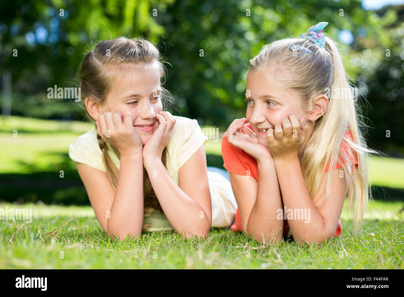 Happy sisters smiling to each other Stock Photo - Alamy