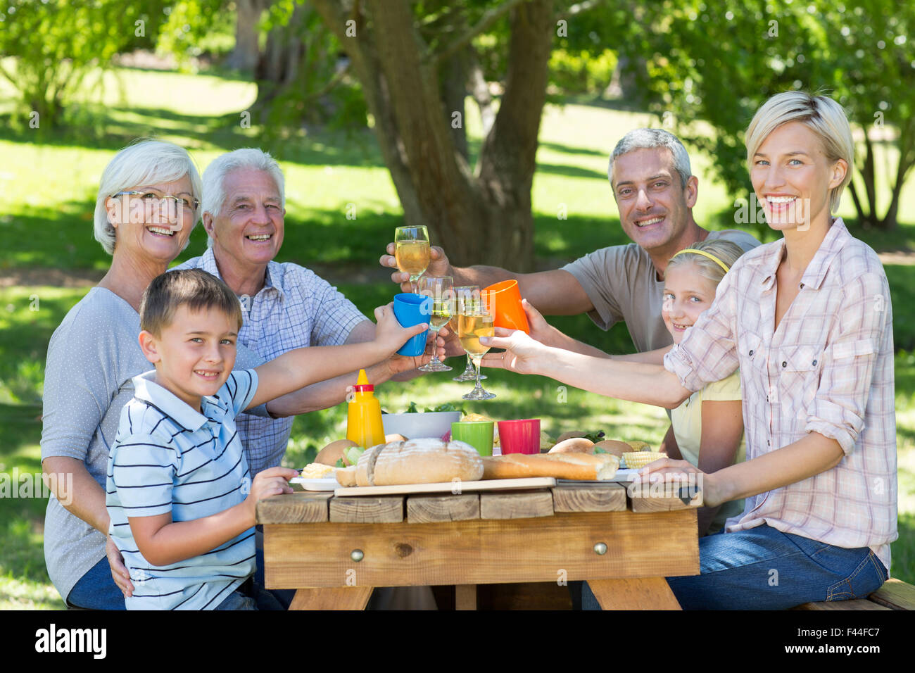 Happy family having picnic in the park Stock Photo - Alamy