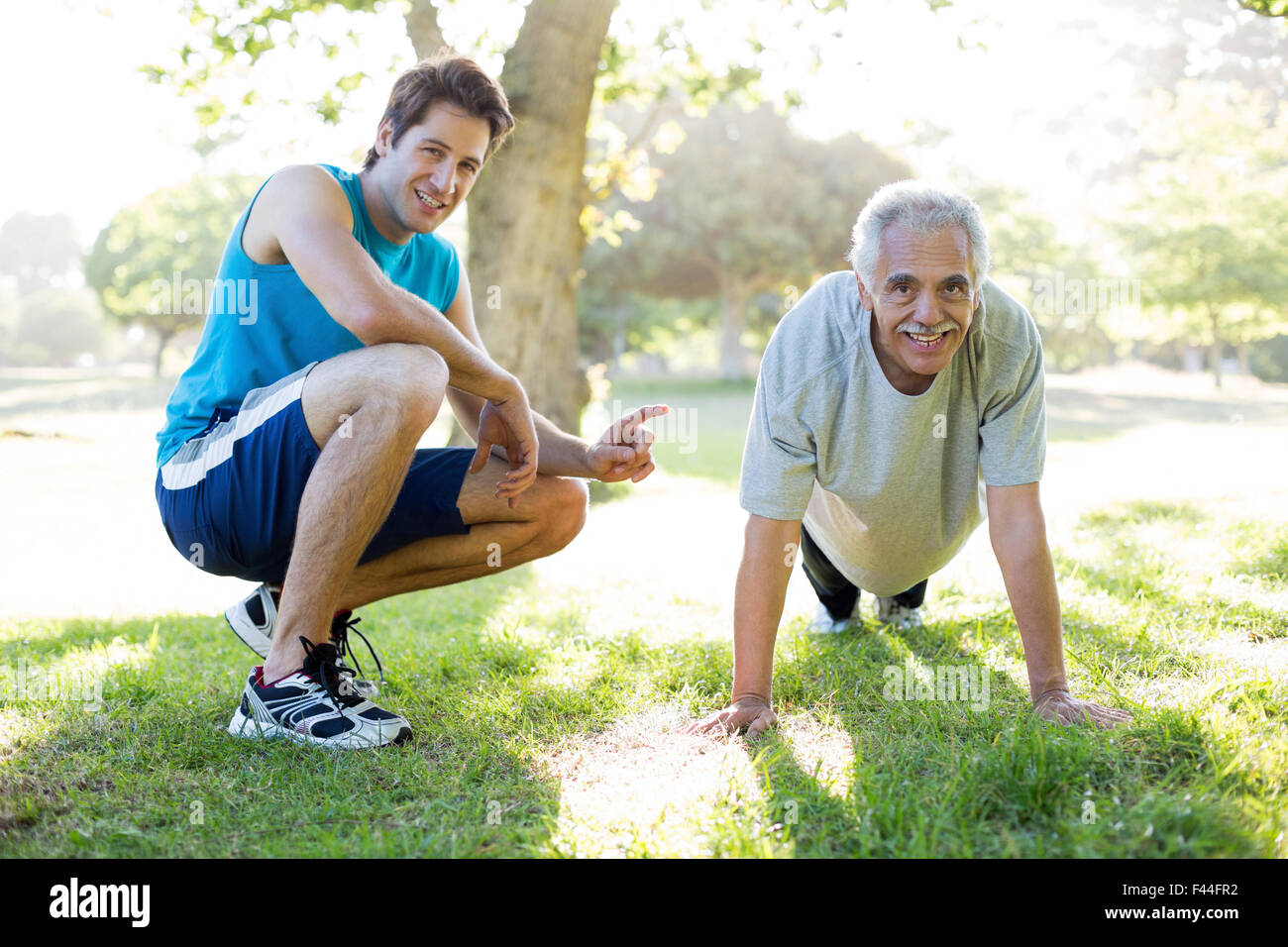 Happy senior training with a coach Stock Photo - Alamy
