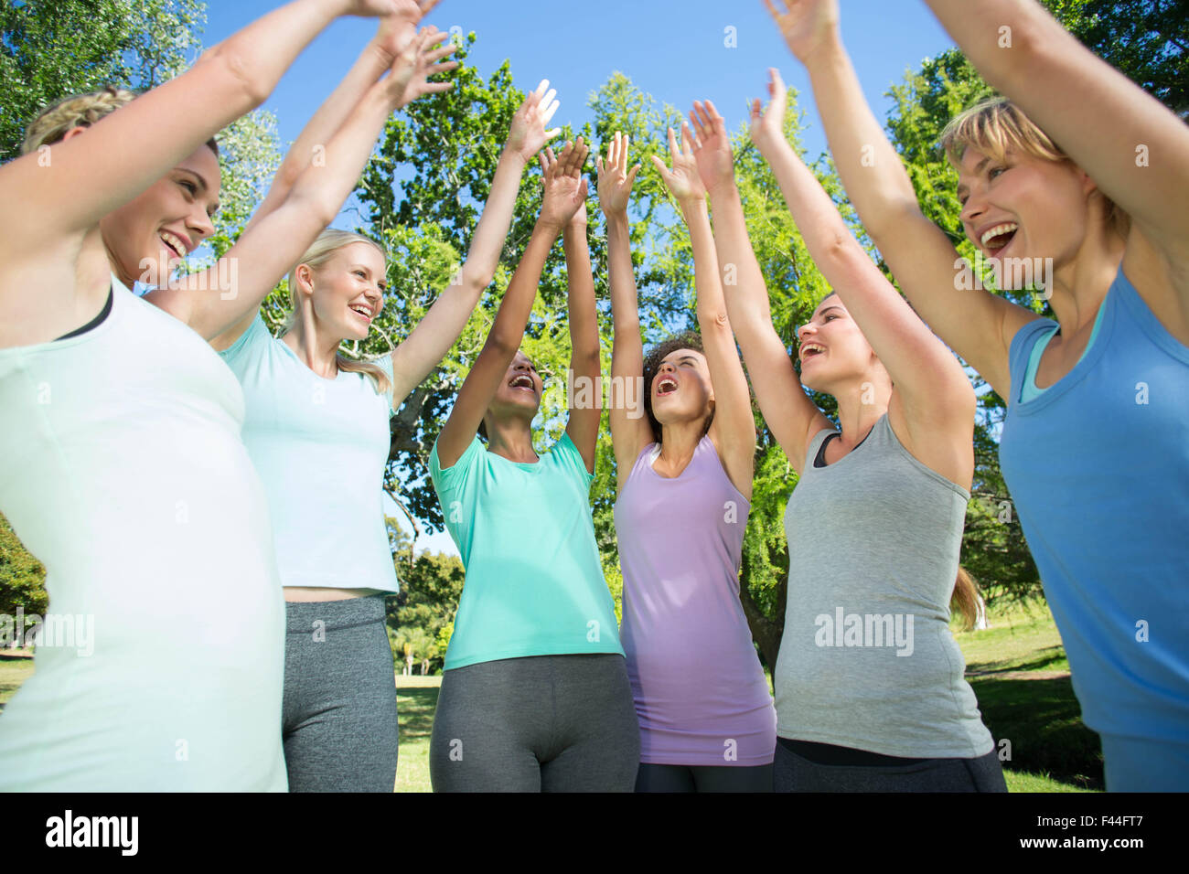 Fitness group putting hands together Stock Photo - Alamy