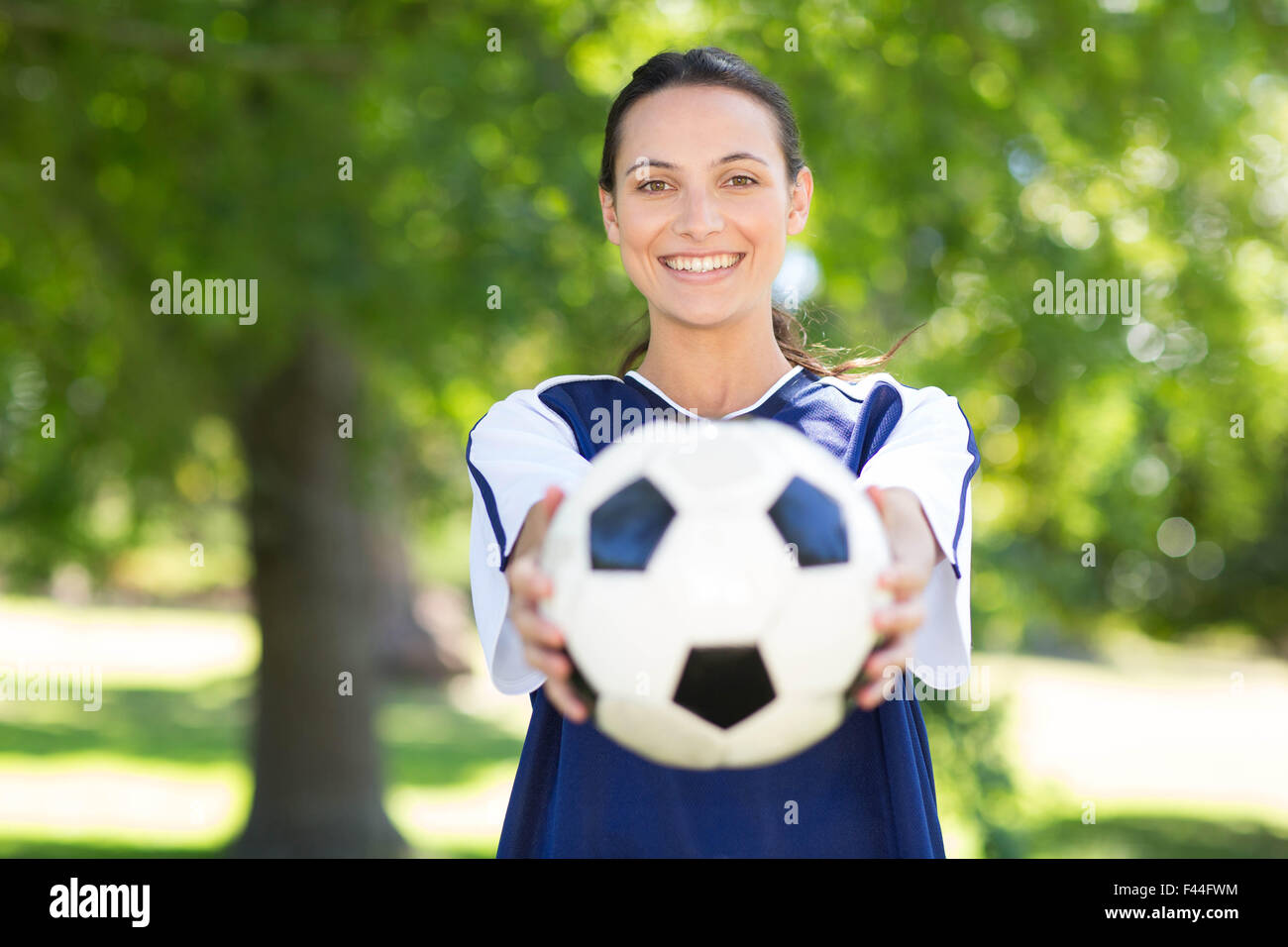 Pretty football player smiling at camera Stock Photo - Alamy